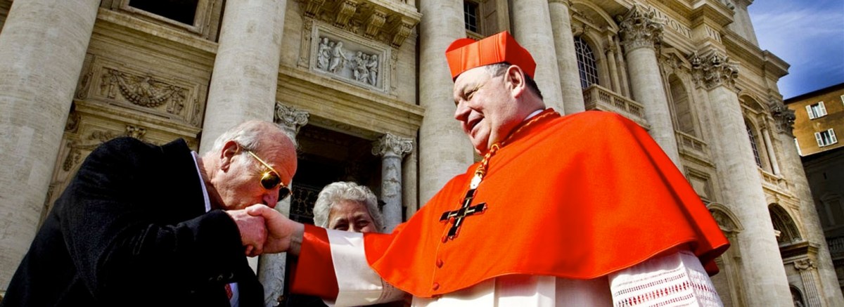Cardinal pray to saint with two skulls